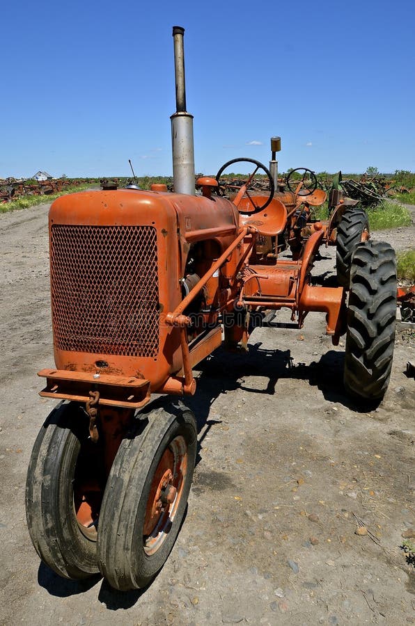 Old Orange Tractor in a Junkyard Stock Photo - Image of overhauled ...