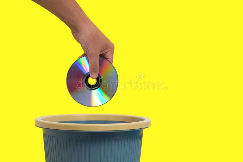 Old, Outdated CD in Your Hand is Thrown into Trash.Yellow Background ...