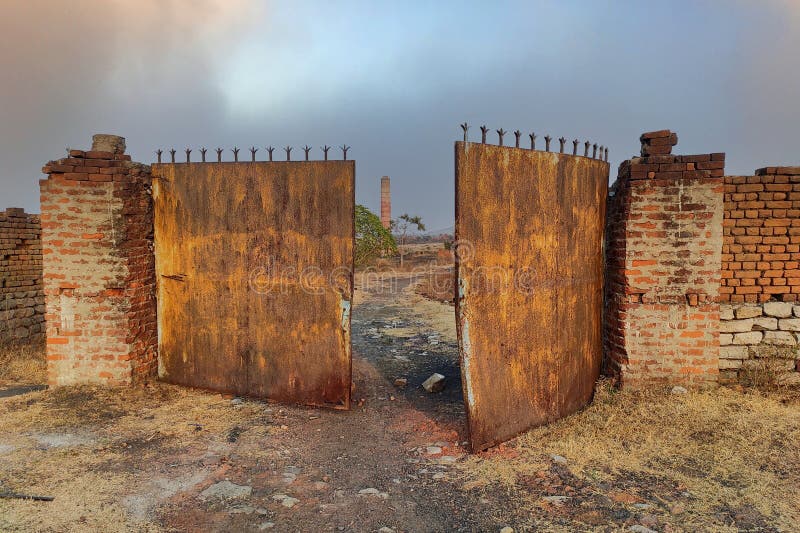 The Old Outer Wall and Broken Iron Gate of an Abandoned Factory Stock ...