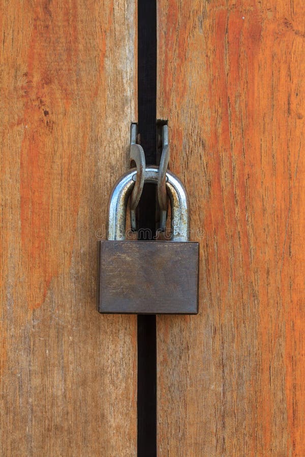 Old padlock on wooden door stock image. Image of oxidize - 34036307