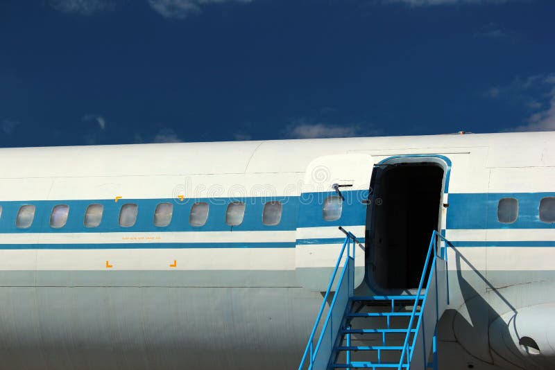Old Passenger Aircraft Door and Windows Against Blue Sky Background ...