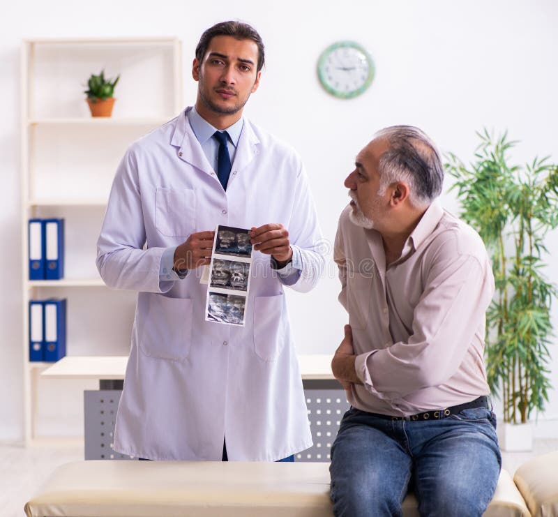 Old Patient Visiting Young Male Doctor Stock Image - Image of physician ...