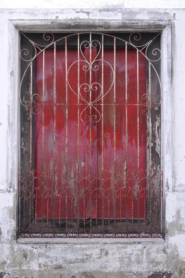 Old Pattern Rust Wrought Iron on Red Window Stock Image - Image of ...
