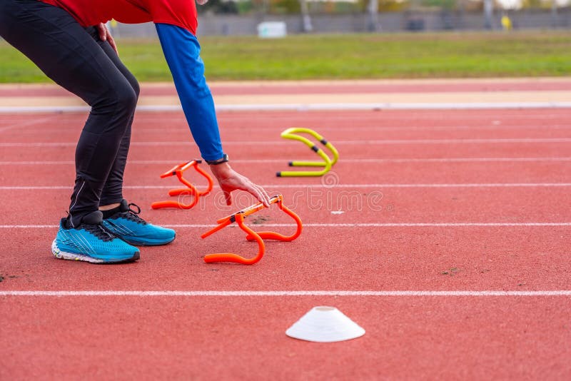 Old Person Preparing a Running Track with Training Elements Stock Photo ...