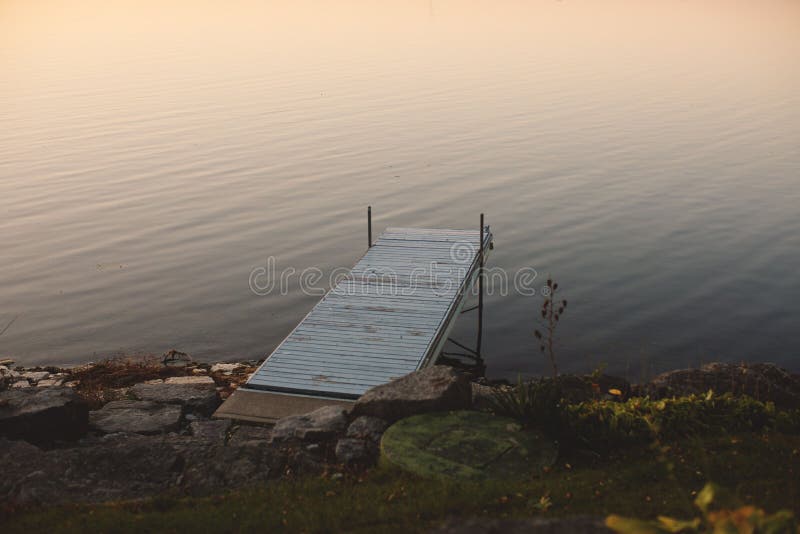 Old Pier on the Shore of the Lake Under the Sunset Light Stock Photo ...