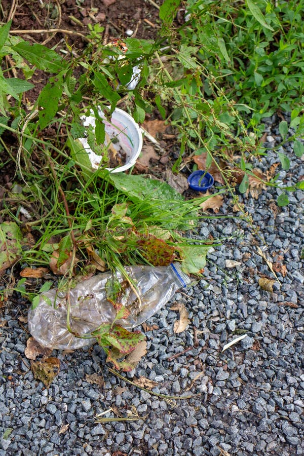 Old Plastic Bottle and Cup Discarded on the Side of the Road Stock ...