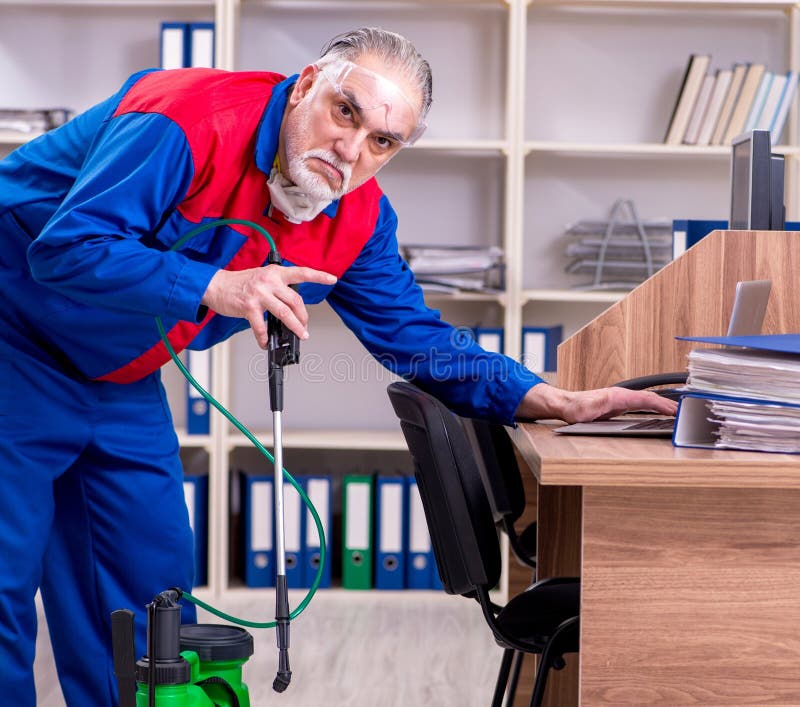 Old Professional Contractor Doing Pest Control in the Office Stock ...