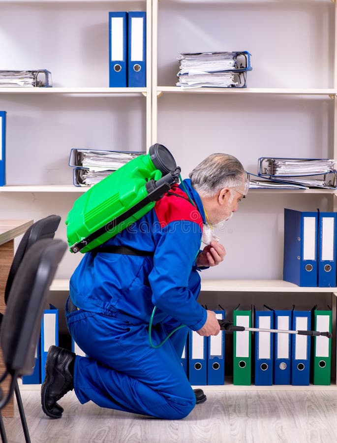 Old Professional Contractor Doing Pest Control in the Office Stock ...