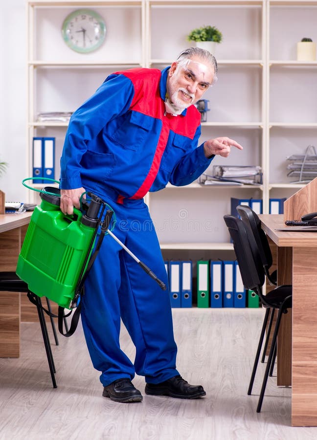 Old Professional Contractor Doing Pest Control in the Office Stock ...