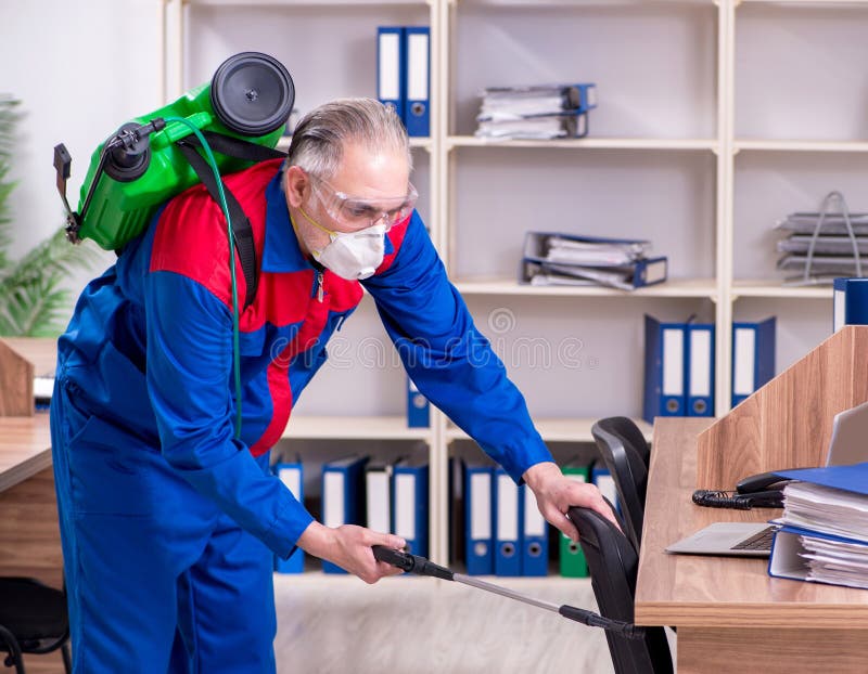 Old Professional Contractor Doing Pest Control in the Office Stock ...