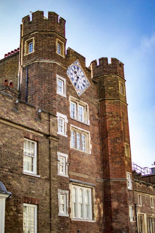 An Old Red Brick Building with a Clock Tower and Round Columns Stock ...