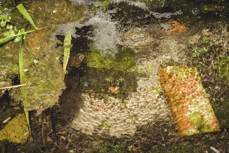Old Red Brick and Garbage in Clear Creek Water. Stock Photo - Image of ...