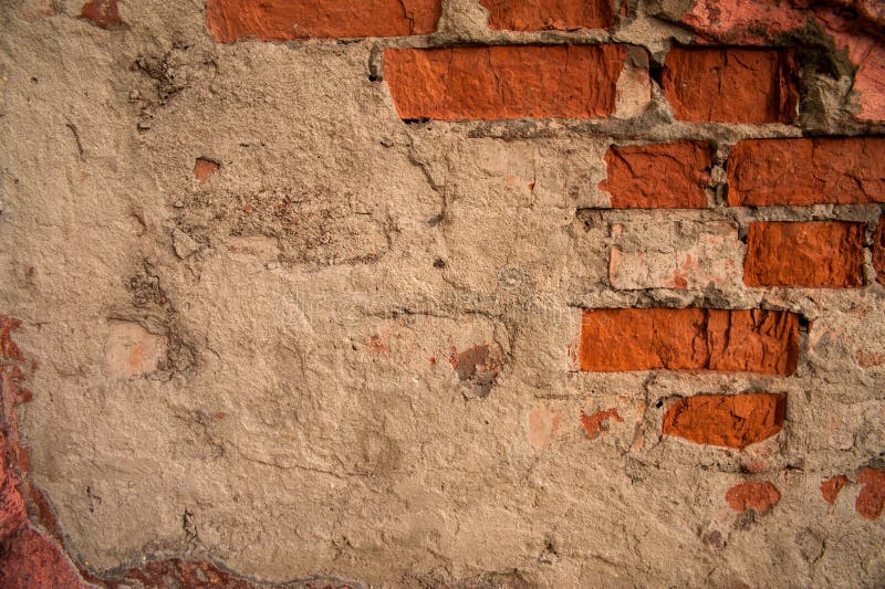 An Old Red Brick Wall with a Piece of Gray Plaster Falling Off Stock ...