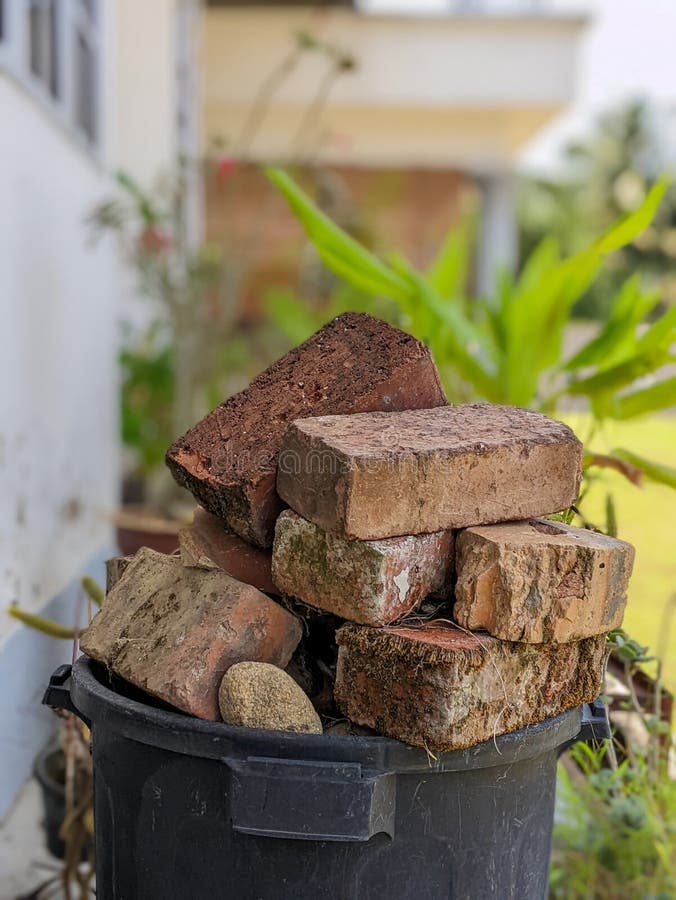Old Red Bricks Stacked in a Black Trash Bin Outdoors Stock Photo ...