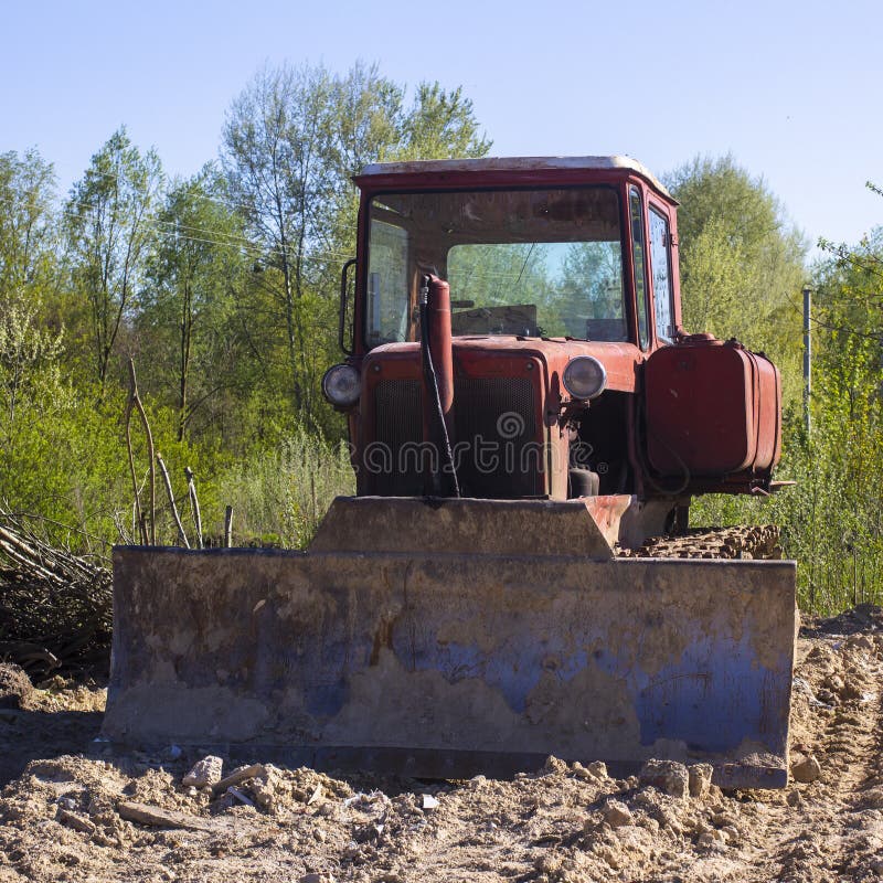 Old Red Bulldozer on a Background of Trees. Front View Stock Photo ...