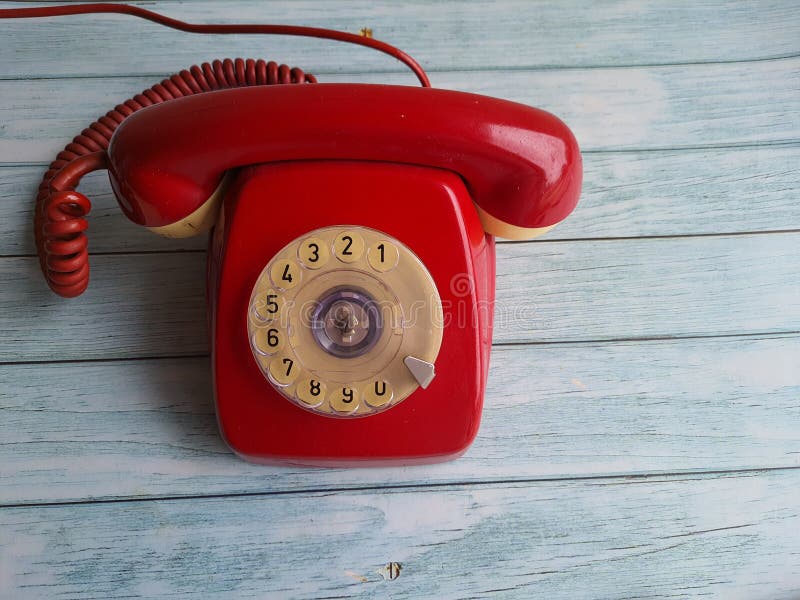 Old Red Dial Telephone Isolated on Wooden Table. Stock Photo - Image of ...