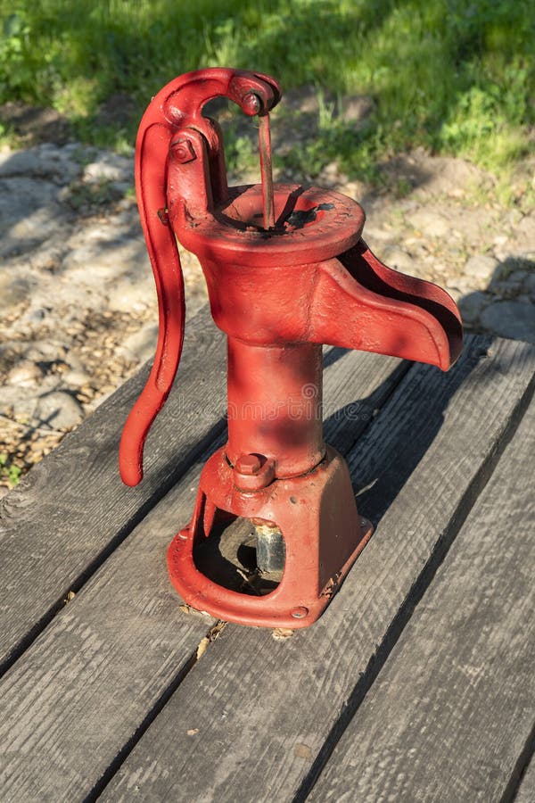 Old Red Hand Water Pump Mounted on Wood Planks Stock Image - Image of ...