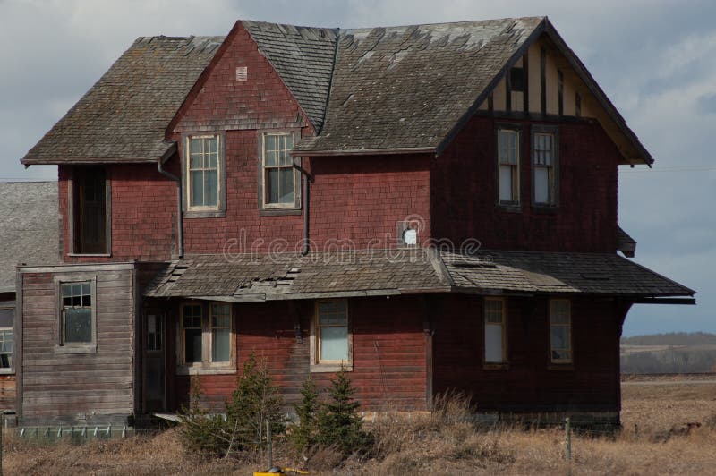 Old Red House in a Dry Grassy Field Under a Cloudy Sky Stock Photo ...