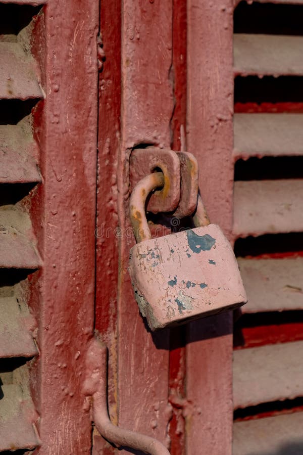 Old Red Padlock Covered with Rust on the Red Door Stock Image - Image ...