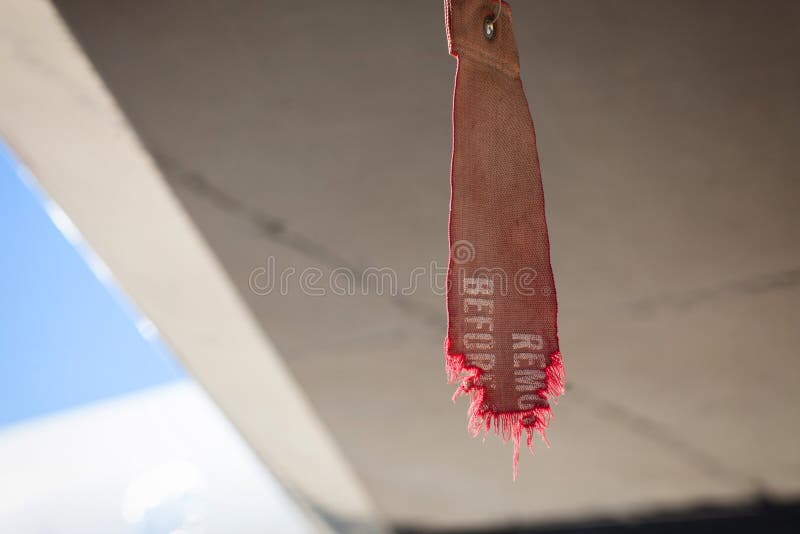 Old Red Remove before Flight Tag on an Airplane Fuselage Stock Image ...