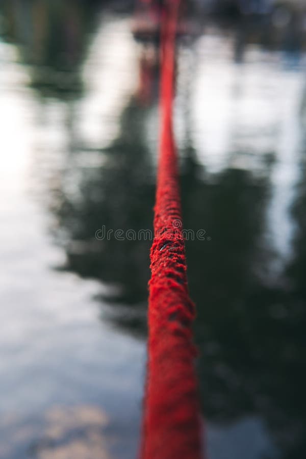 Old Red Rope Pulled Over Water, Selective Focus, Close, Details, Torn ...