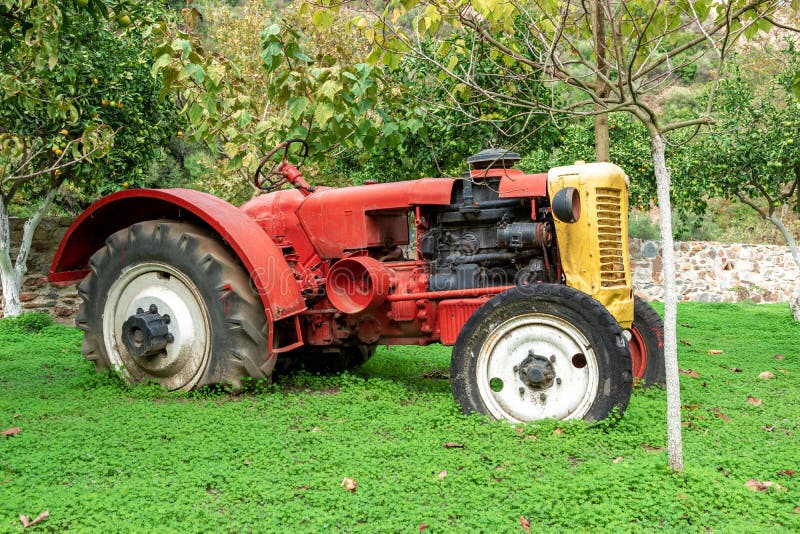 A Old Red Rusty Tractor in the Garden with Trees Stock Image - Image of ...