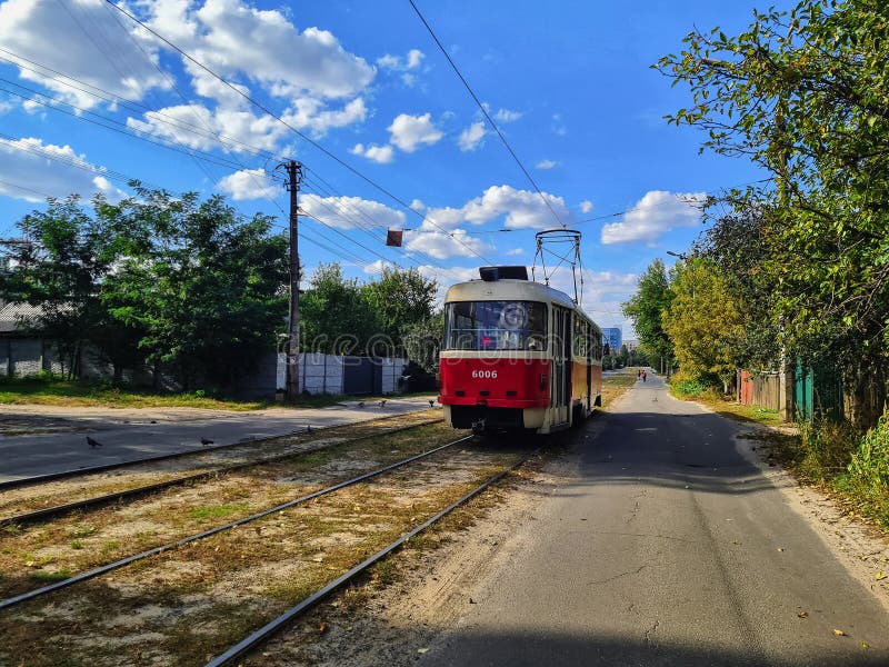 An Old Red Tram Rides on Rails Stock Photo - Image of cityscape ...