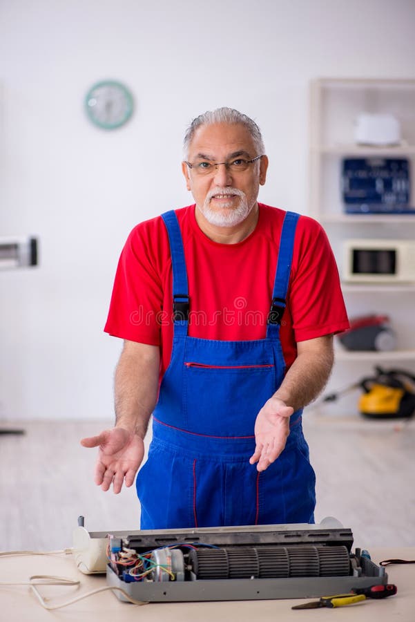 Old Repairman Repairing Air-conditioner at Workshop Stock Image - Image ...