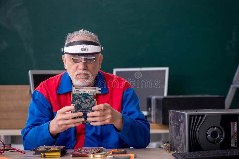 Old Repairman Repairing Computers in the Classroom Stock Photo - Image ...