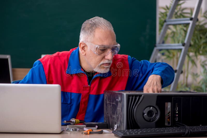 Old Repairman Repairing Computers in the Classroom Stock Image - Image ...