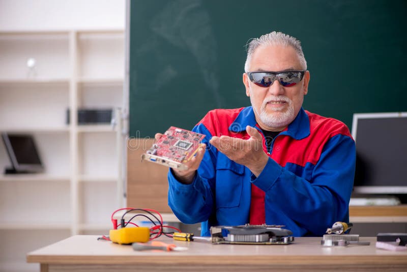 Old Repairman Repairing Computers in the Classroom Stock Photo - Image ...