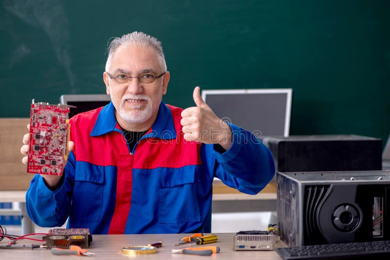 Old Repairman Repairing Computers in the Classroom Stock Photo - Image ...