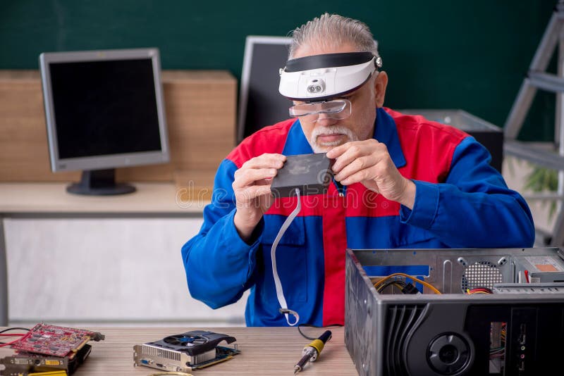 Old Repairman Repairing Computers in the Classroom Stock Photo - Image ...