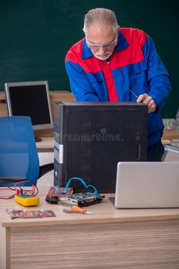 Old Repairman Repairing Computers in the Classroom Stock Photo - Image ...