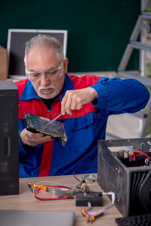 Old Repairman Repairing Computers in the Classroom Stock Image - Image ...