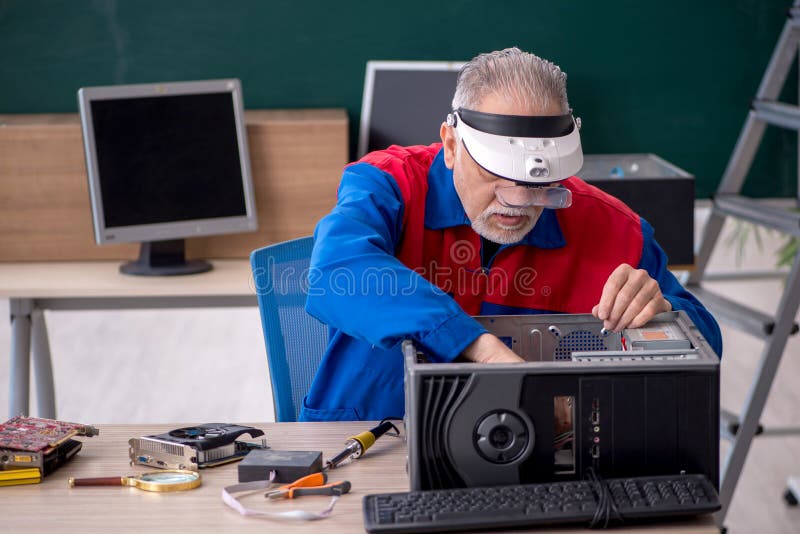 Old Repairman Repairing Computers in the Classroom Stock Image - Image ...