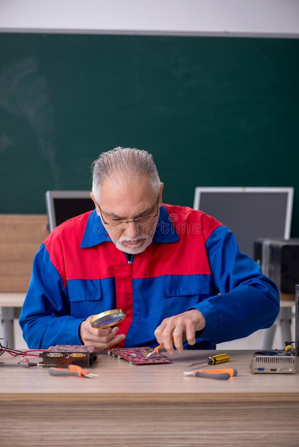 Old Repairman Repairing Computers in the Classroom Stock Photo - Image ...