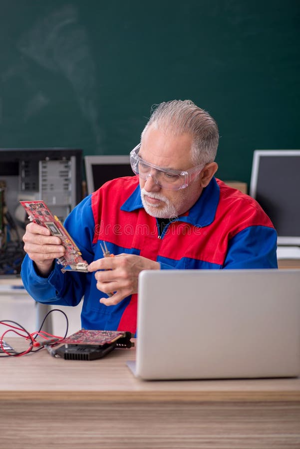 Old Repairman Repairing Computers in the Classroom Stock Image - Image ...