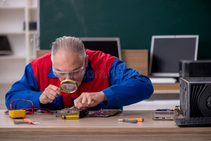 Old Repairman Repairing Computers in the Classroom Stock Photo - Image ...