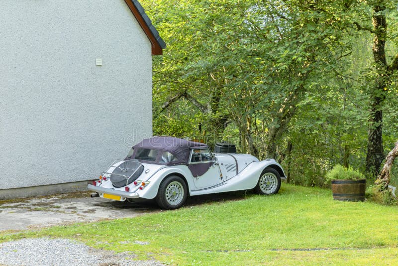 Old Retro Luxury Car in Front of Building in Scottish Village Stock ...