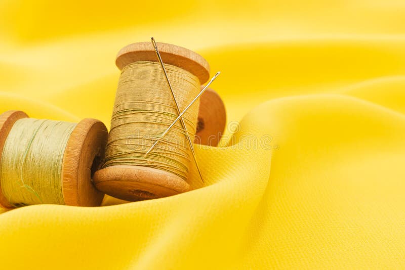 Old Retro Sewing Accessories Lie on a Yellow Fabric. Needle and Thread ...