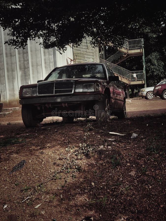 Old Red Car Parked Under Shade of a Tree Stock Image - Image of tree ...
