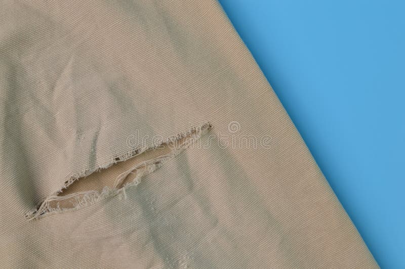 Old Ripped Fabric Man`s Pant Isolated on a Blue Background Stock Image ...