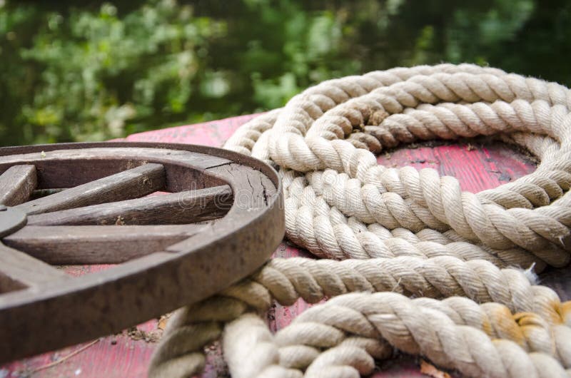 Old Rolled Ropes and a Rusty Wheel Stock Image - Image of ancient, line ...