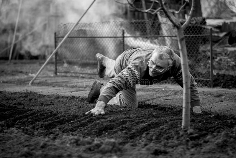 Old Romanian Man Working His Land in a Traditional Way with Empty Hands ...
