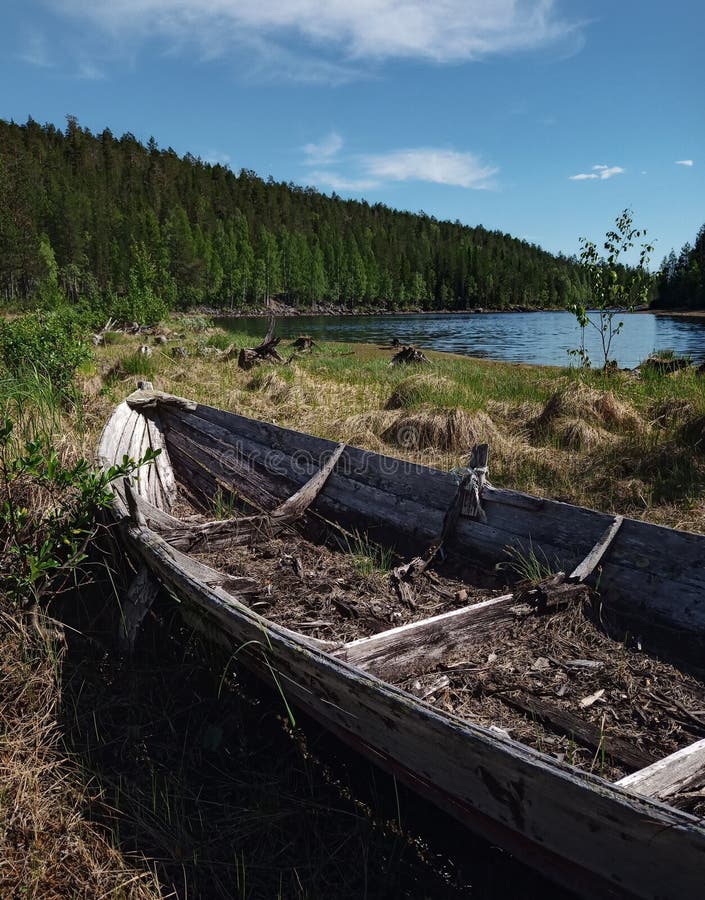 Old Decayed Rowing Boats on Shore of Lake with Stormy Sky Overhead ...