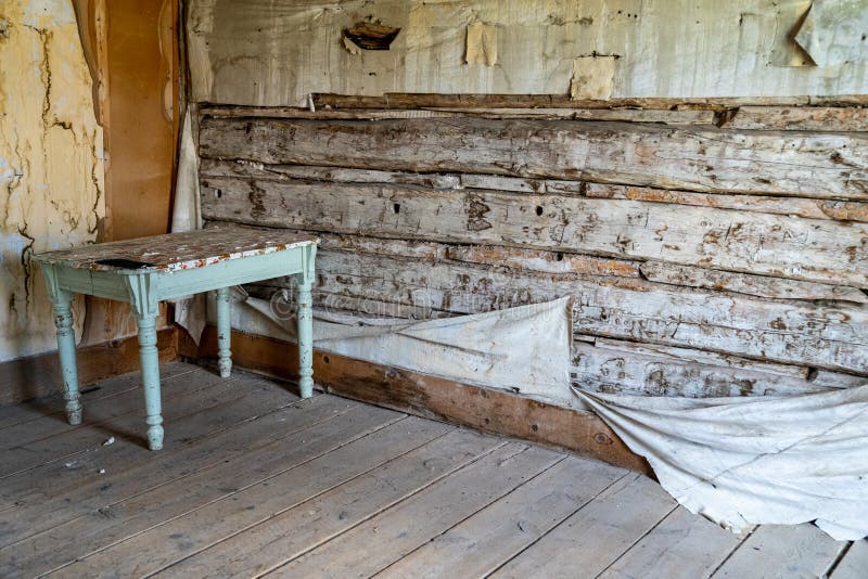 Old, Rotting Walls in an Abandoned Building with a Table Pushed in the ...