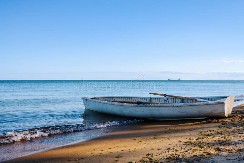 Old Row Boat on Beach with Shadow of Trees. Stock Photo - Image of ...