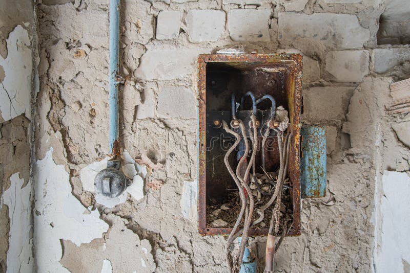 An Old Ruined Junction Box and a Switch on a Peeling Brick Wall of an ...