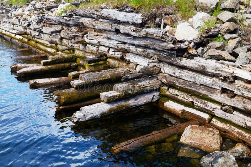 An Old Ruined Pier Made of Tree Logs Near the Lake Shore Stock Image ...